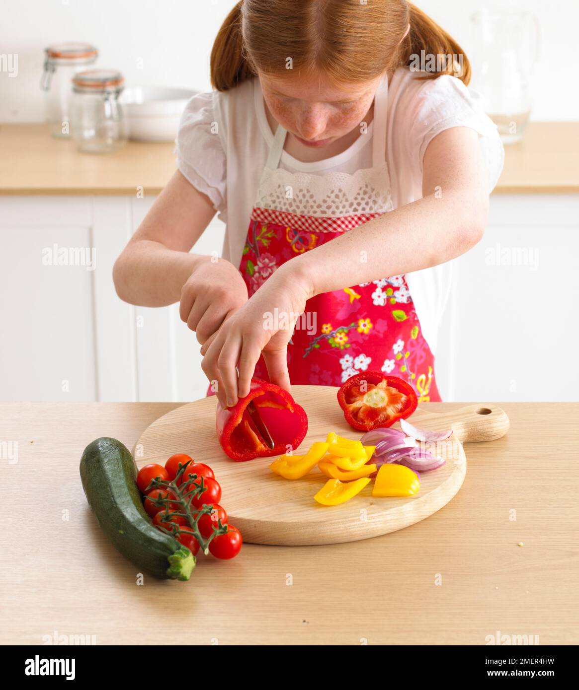 Girl chopping courgette, peppers and tomatoes, 9 years Stock Photo - Alamy