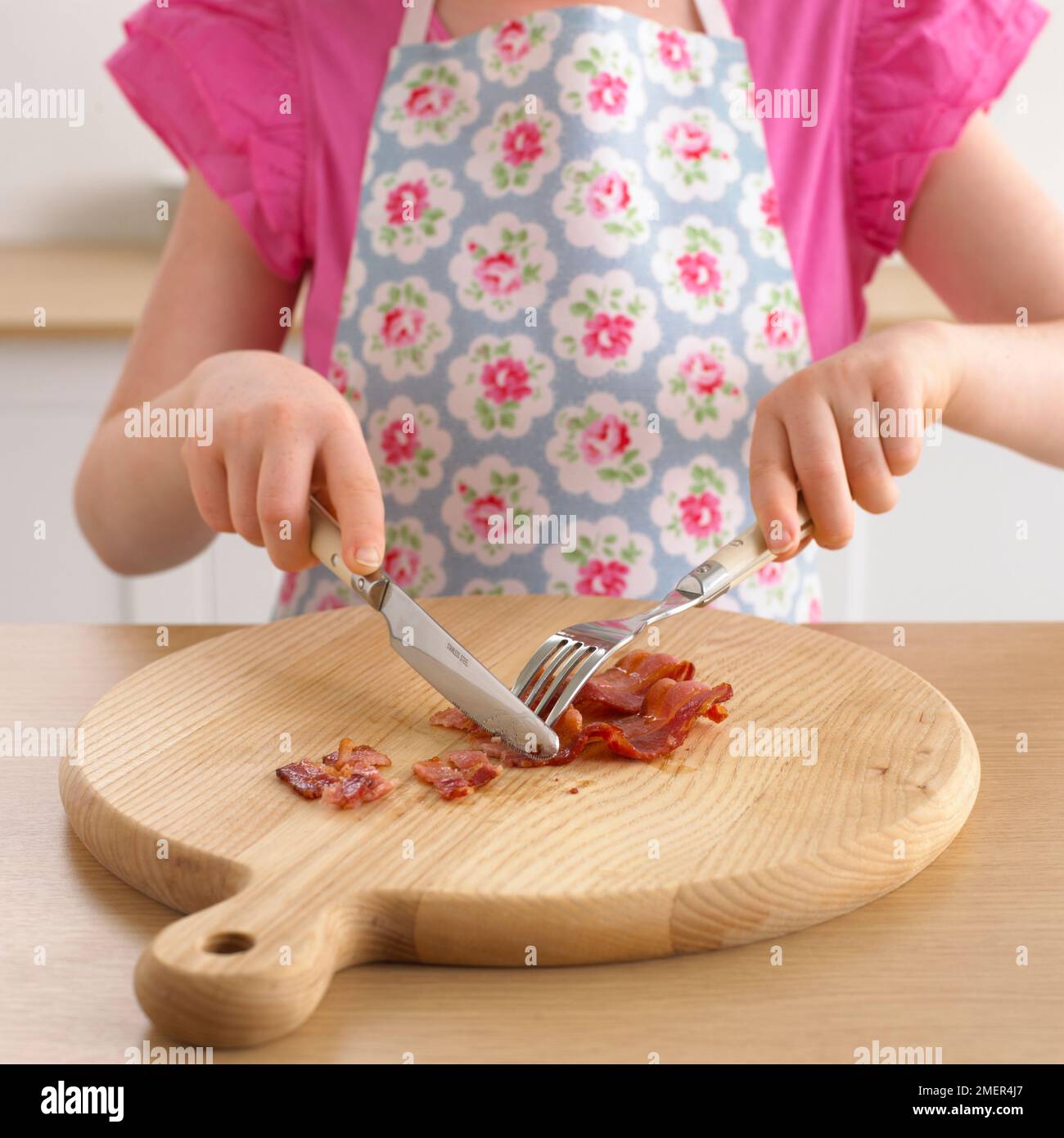 Girl holding up knife fork hi-res stock photography and images - Alamy