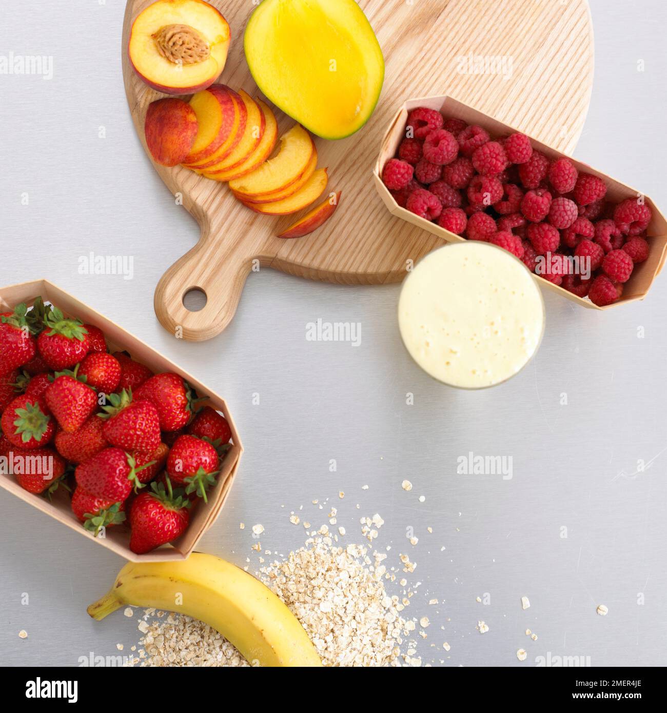 Smoothie ingredients, strawberries, raspberries, sliced peach, mango ...