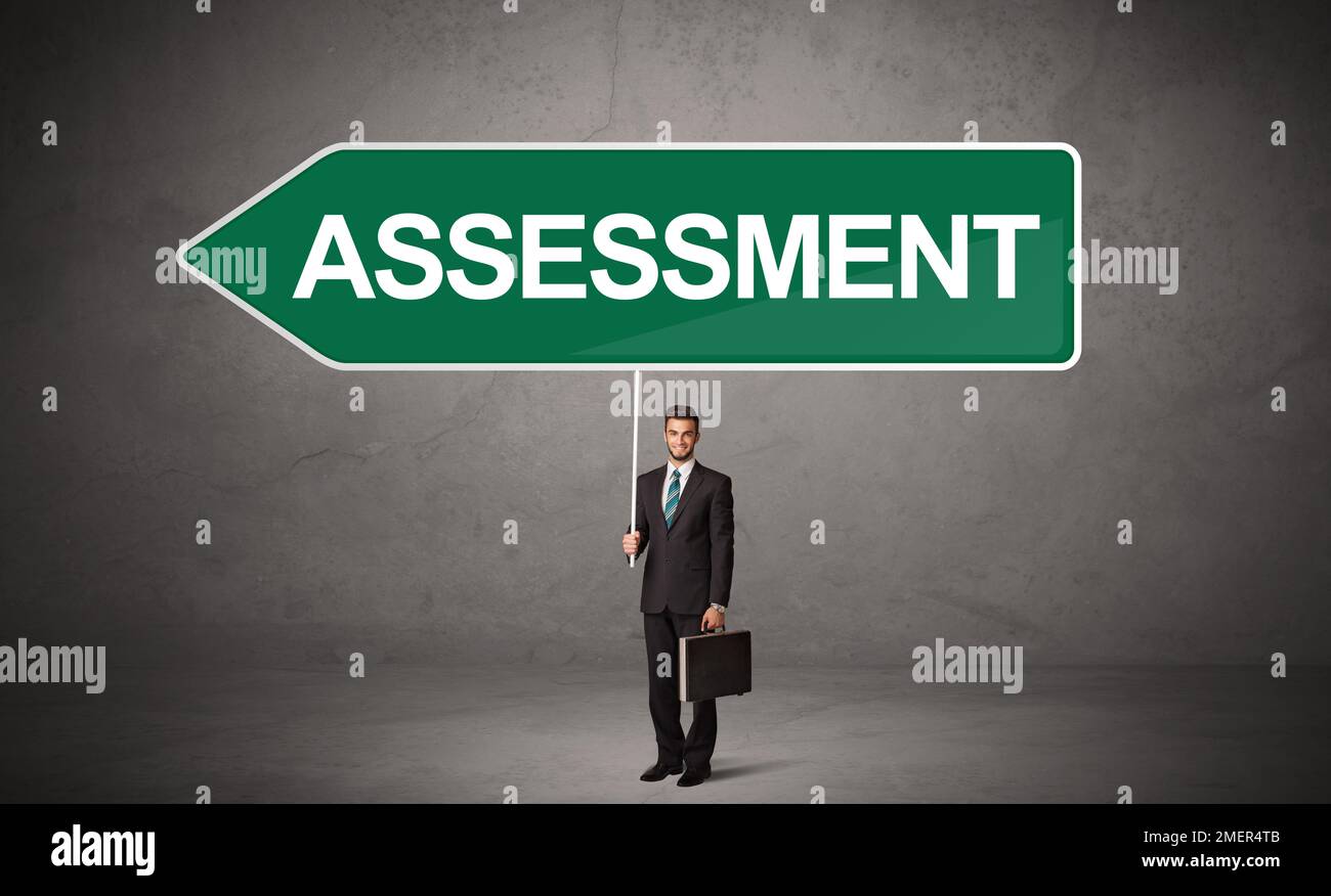 Young business person in casual holding road sign Stock Photo - Alamy