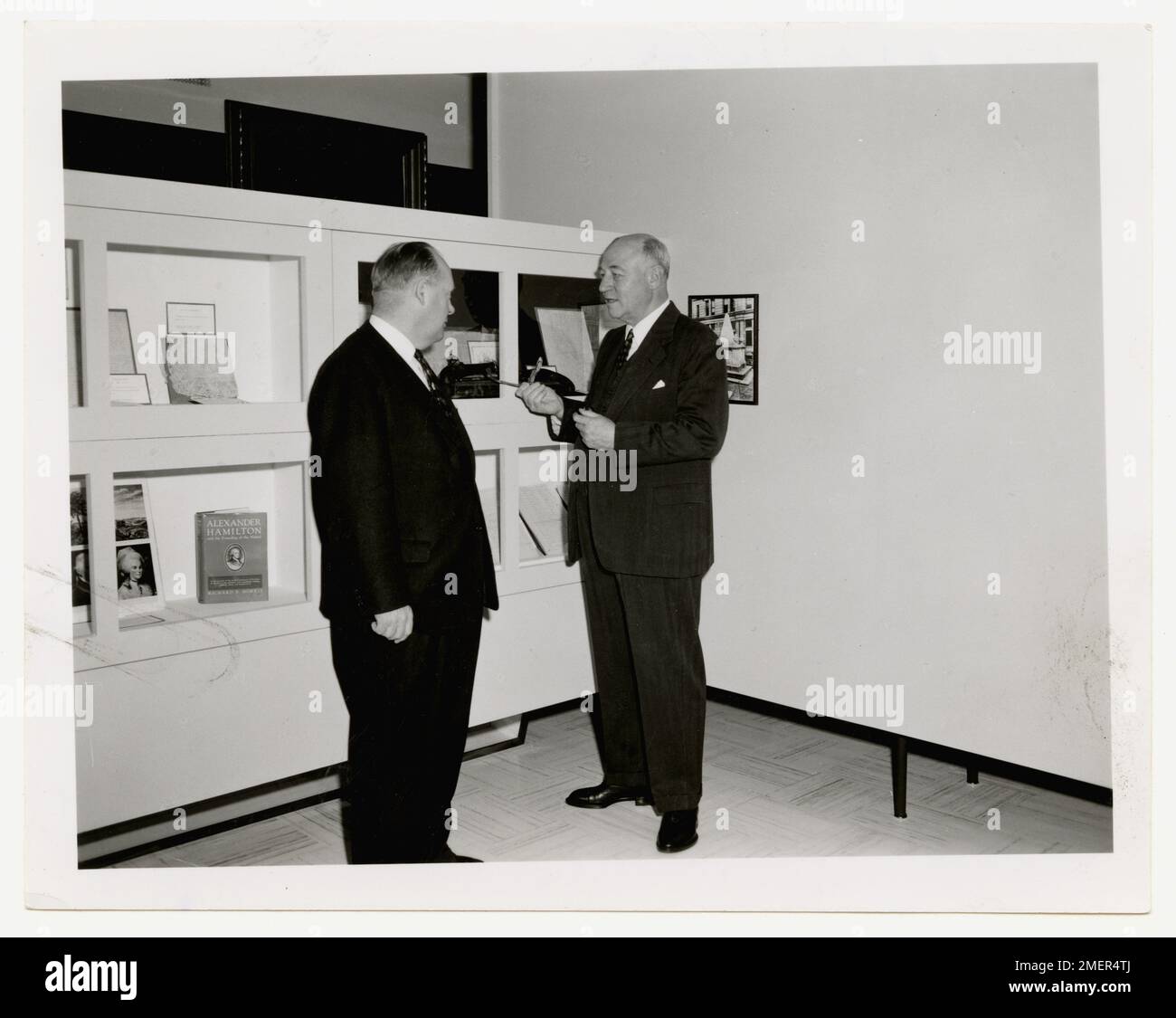 A photograph captures two men inside the Alexander Hamilton Exhibit, a ...