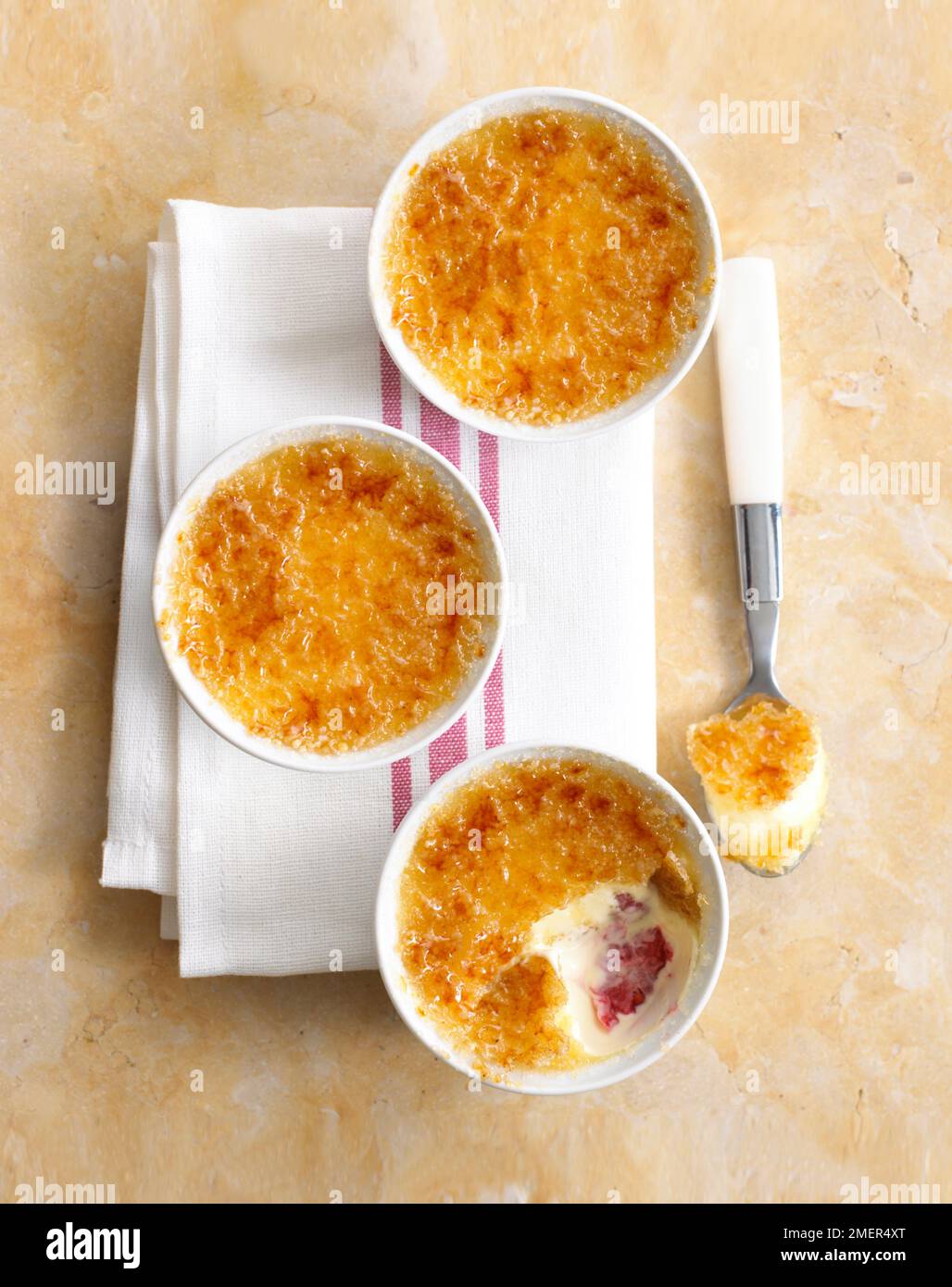 Three ramekins of raspberry creme brulee Stock Photo - Alamy