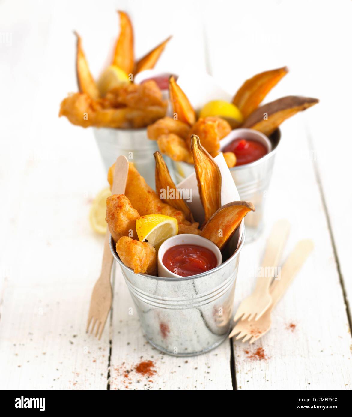 Fish and baked sweet potato wedges in pots served with tomato sauce ...