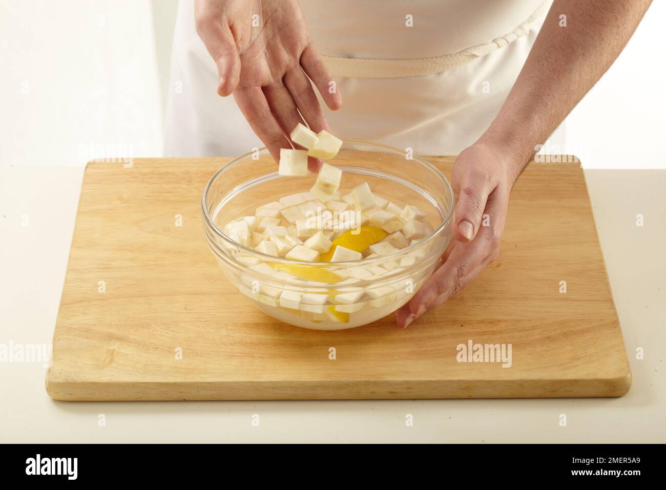 Diced celeriac in bowl of acidulated water Stock Photo - Alamy