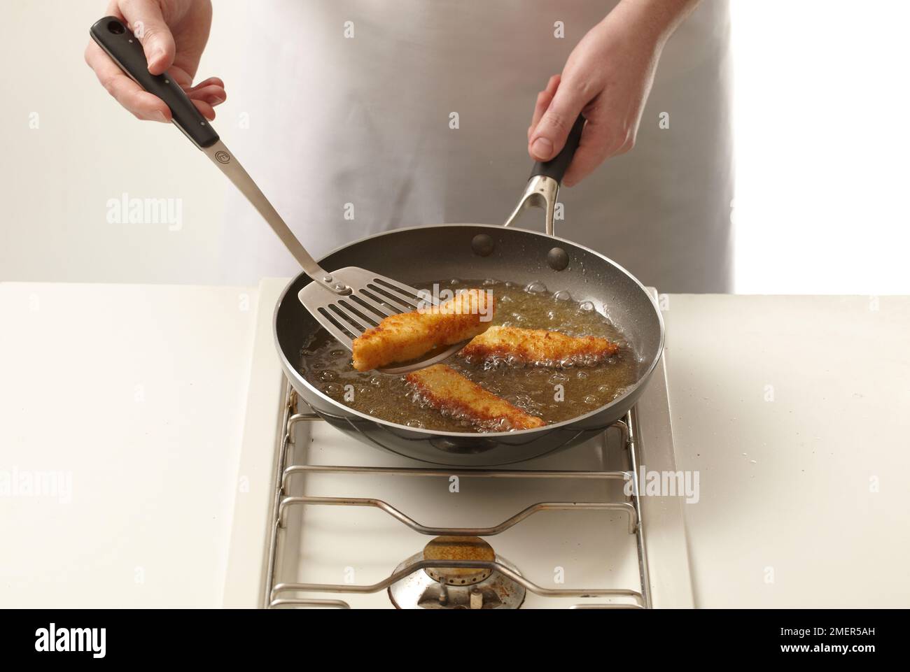 Frying cod goujons Stock Photo - Alamy