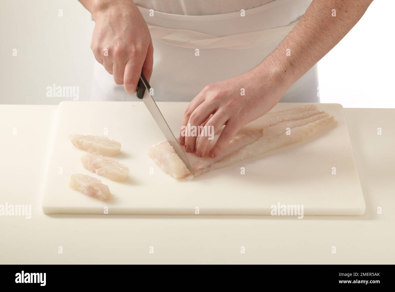 Man hands holding knife slicing hi-res stock photography and images - Alamy
