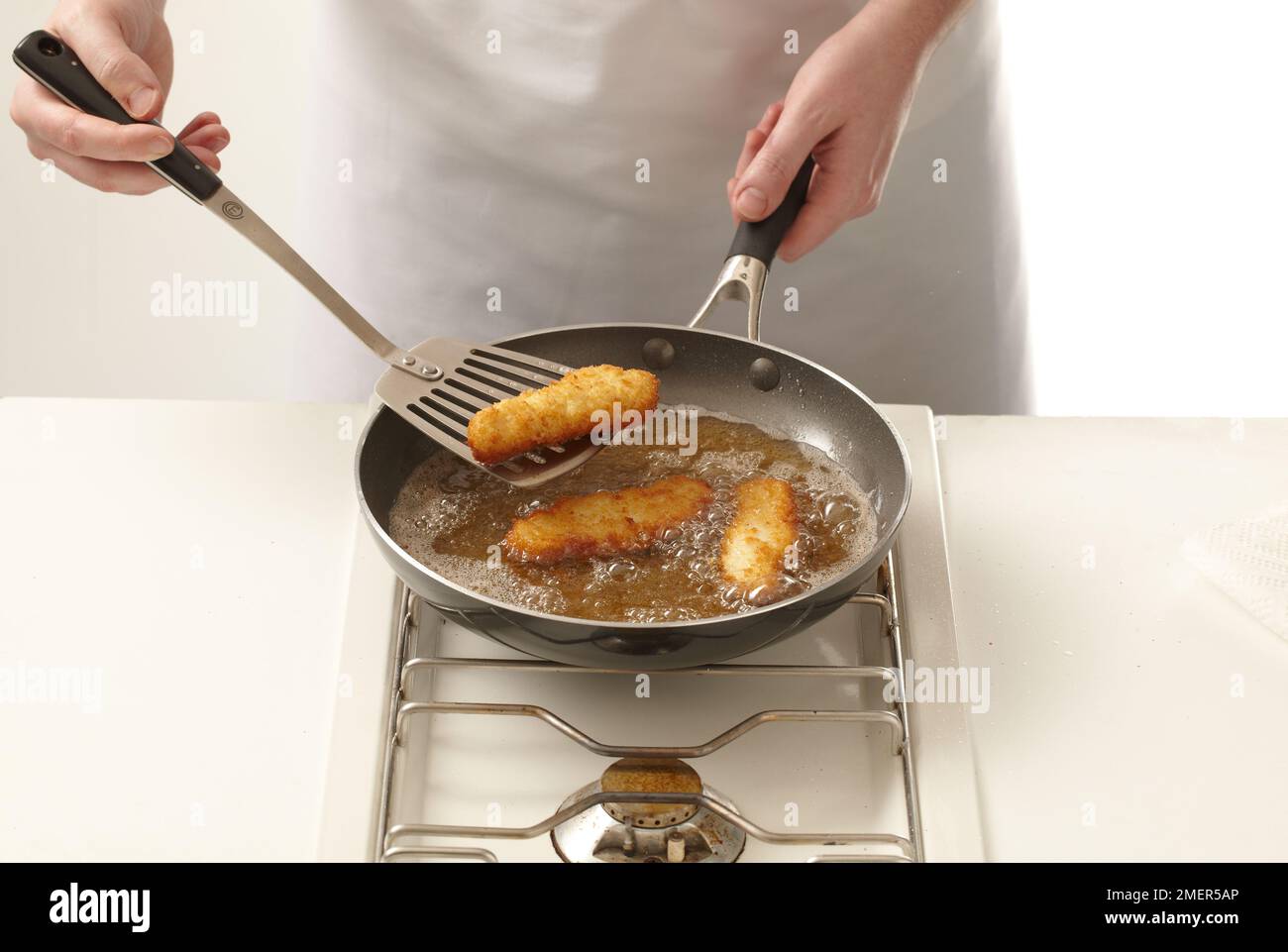 Frying cod goujons Stock Photo - Alamy