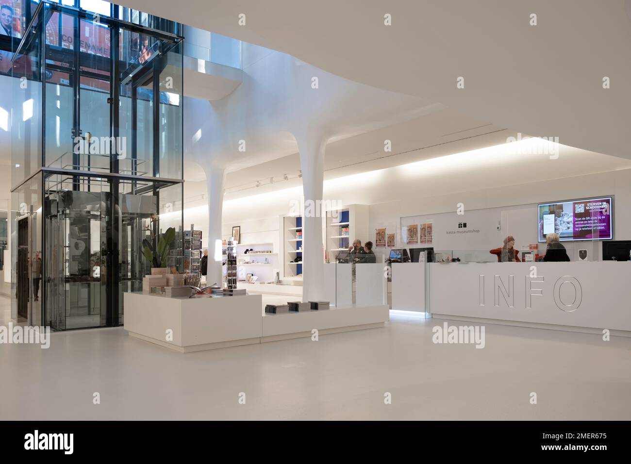 Information desk with staff and on the left the museum shop and ...