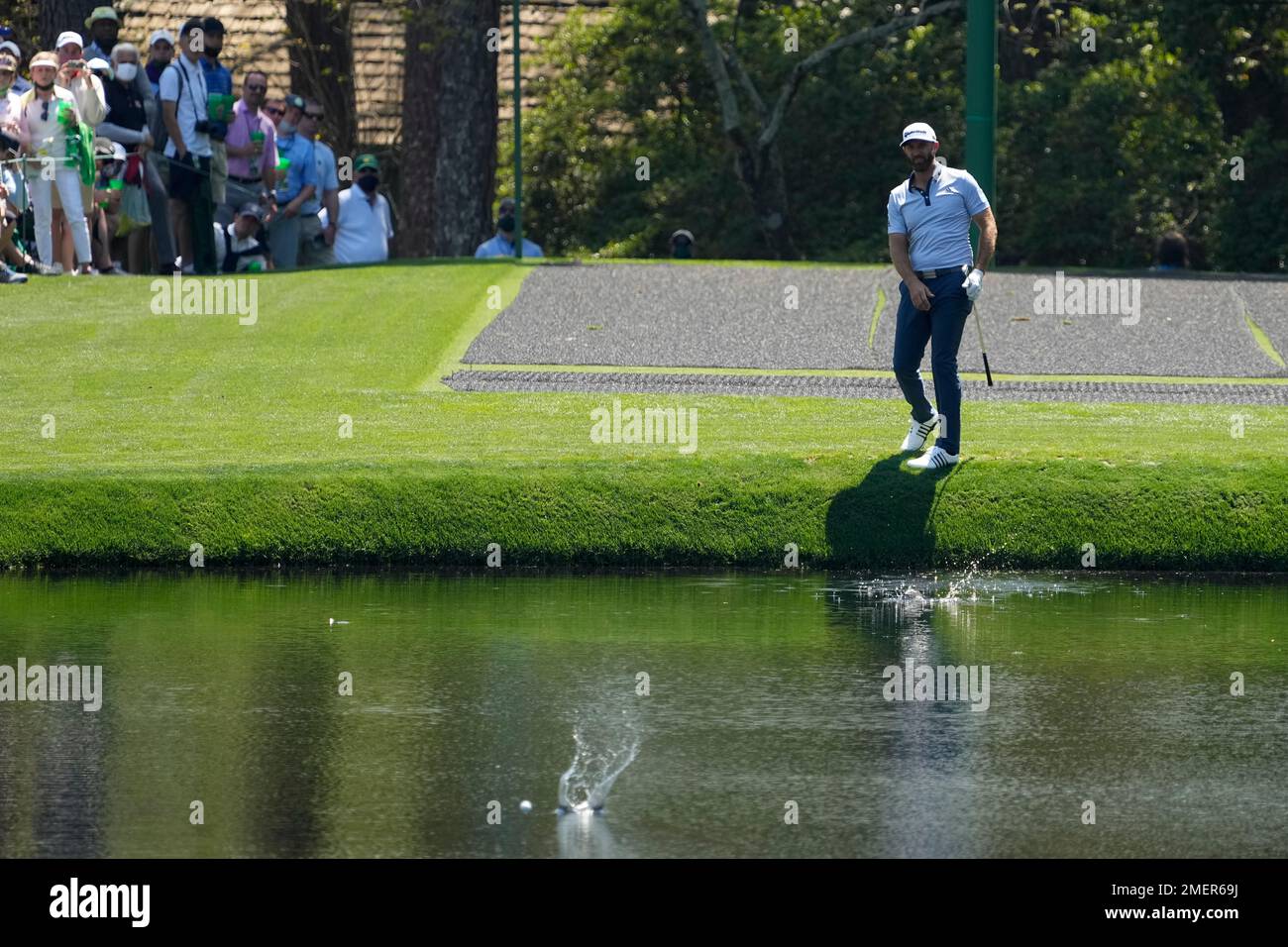 Dustin Johnson skips a ball across the lake onto the green on the 16th ...
