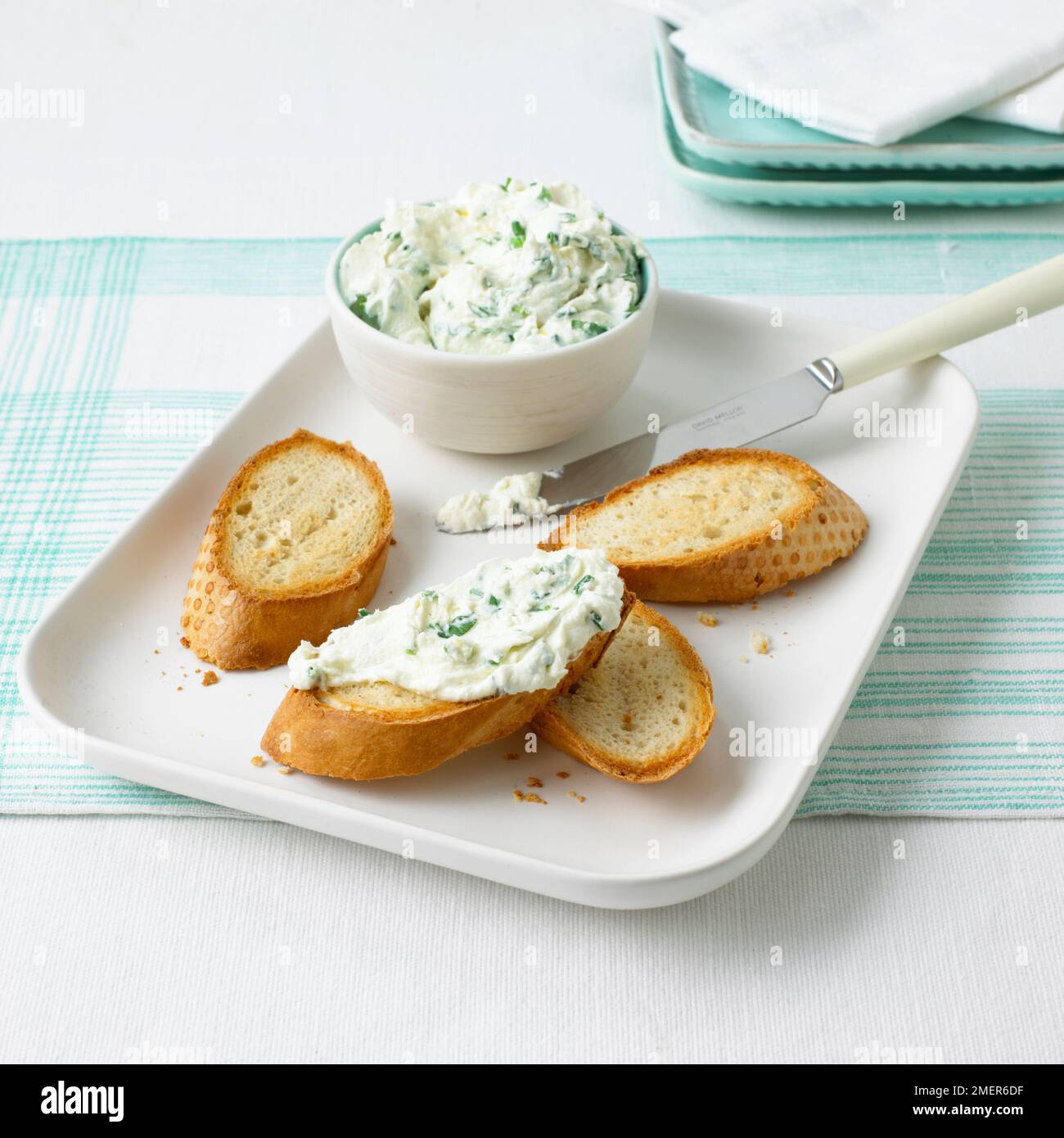 Goats cheese spread on french bread Stock Photo - Alamy