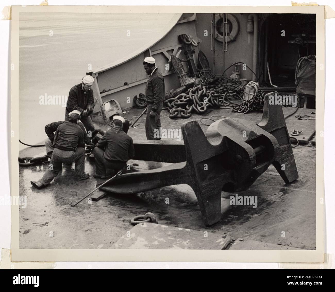 Coast Guardsmen aboard the Buoy Tender LAUREL rig a wire hawser to lift ...