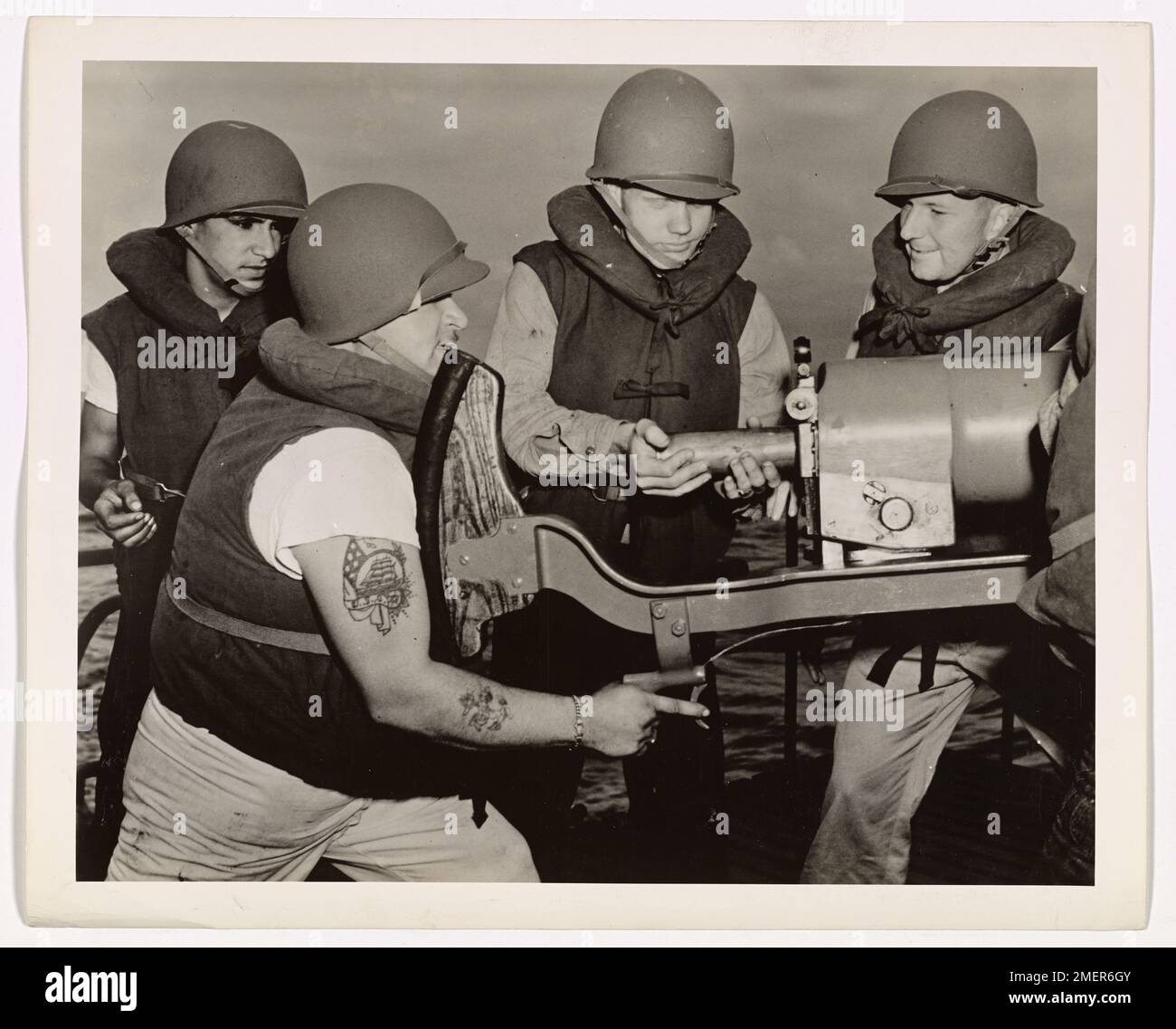 A Coast Guard gun crew conducts training with a light gun used for ...