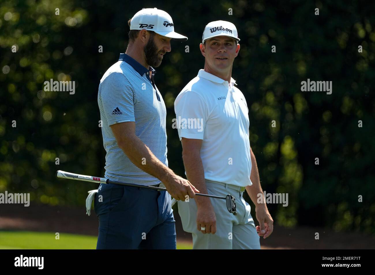 Dustin Johnson and Gary Woodland walk on the 11th hole during a ...