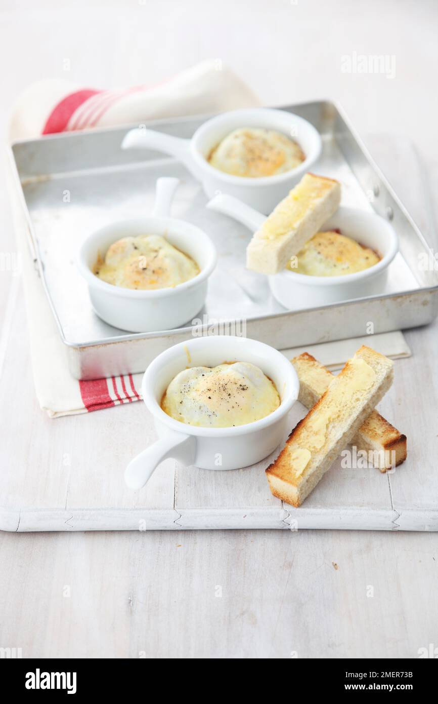 Mini baked egg, ham and cheese with toast fingers Stock Photo - Alamy
