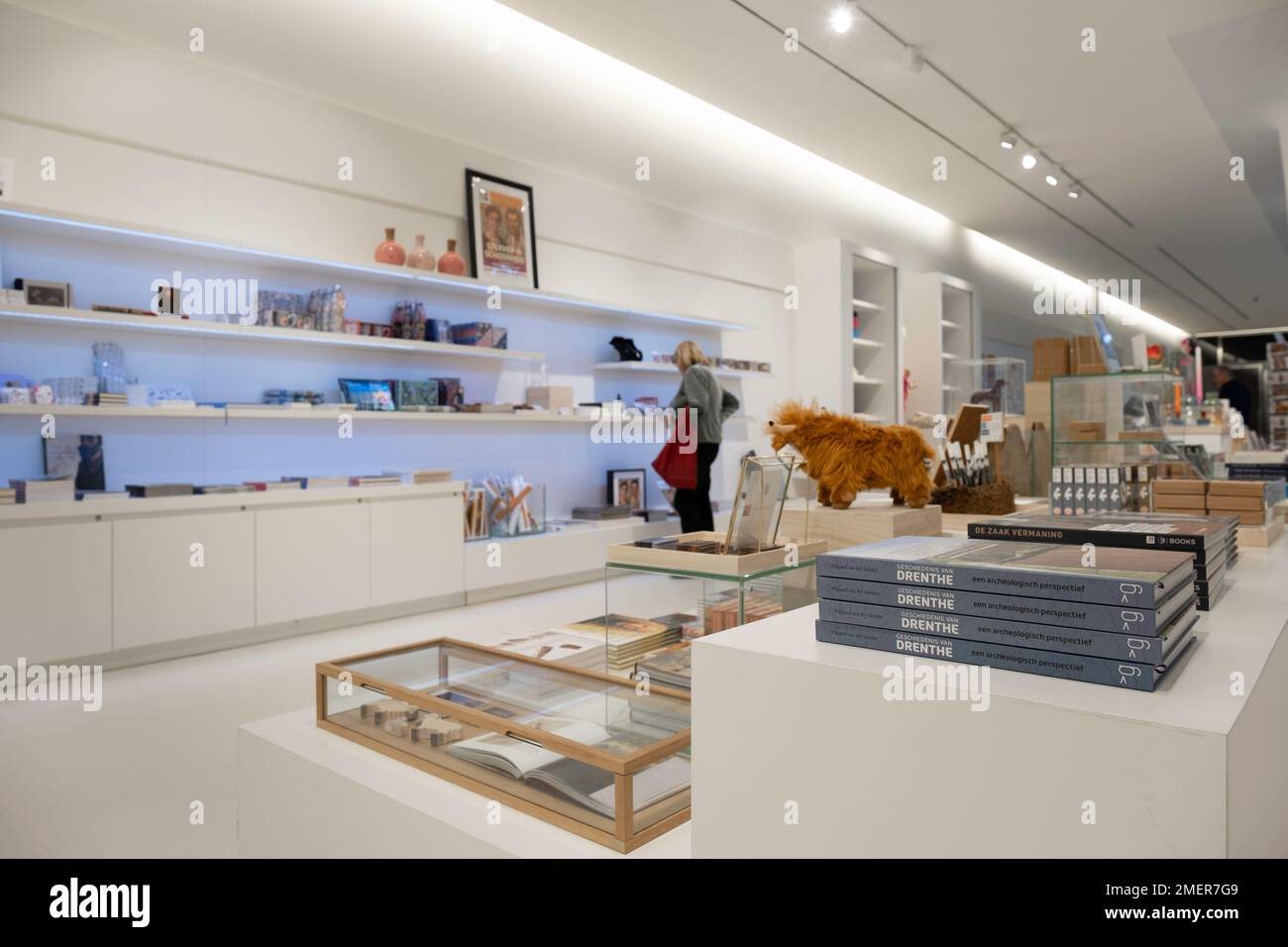 Visitors look around and shop in the modern underground museum shop in ...