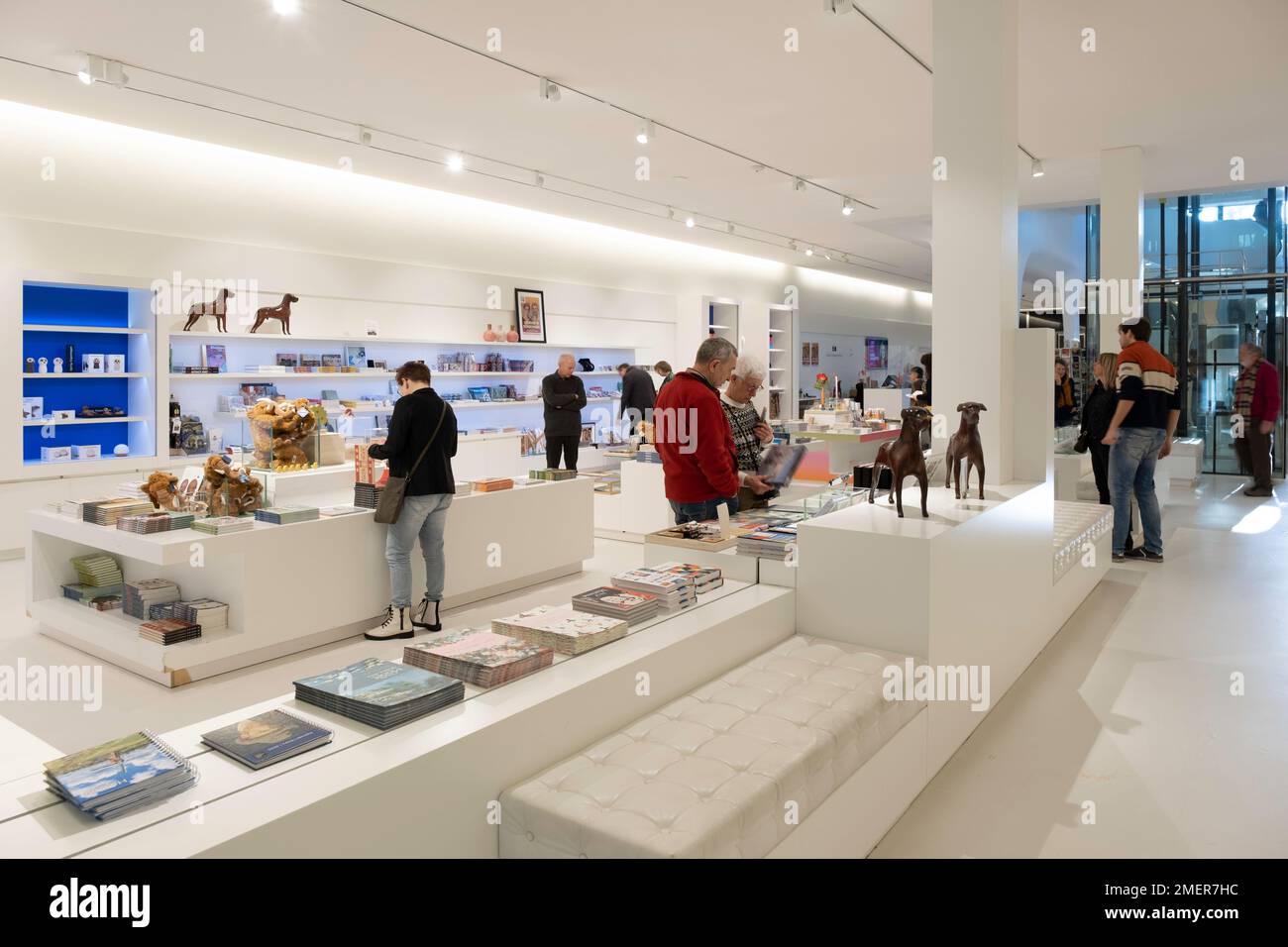 Visitors look around and shop in the modern underground museum shop in ...