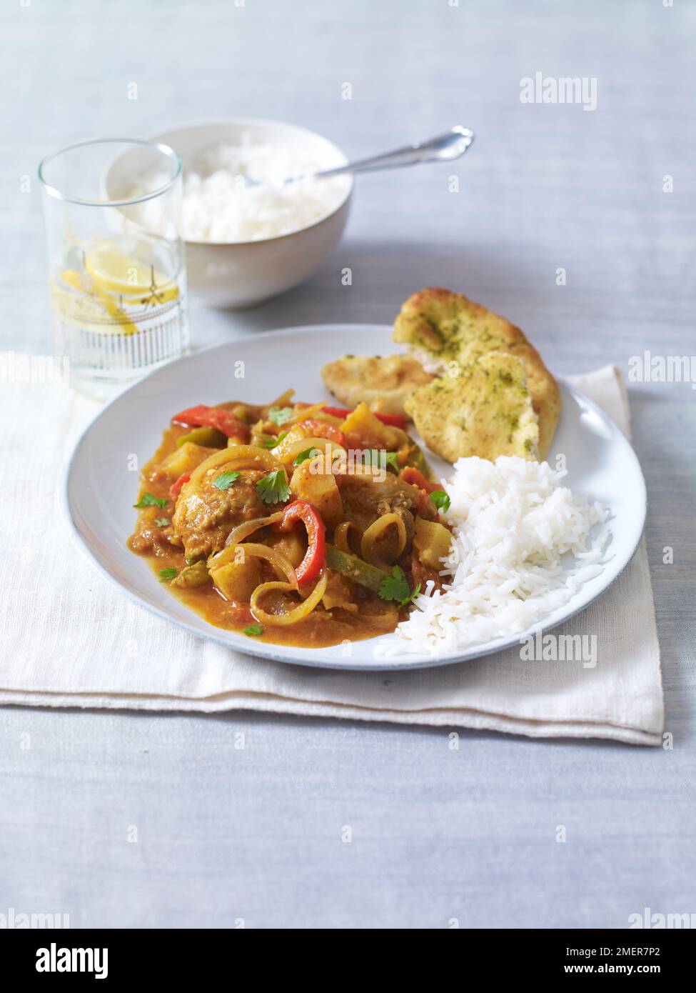 Chicken tomato curry, rice and naan Stock Photo - Alamy