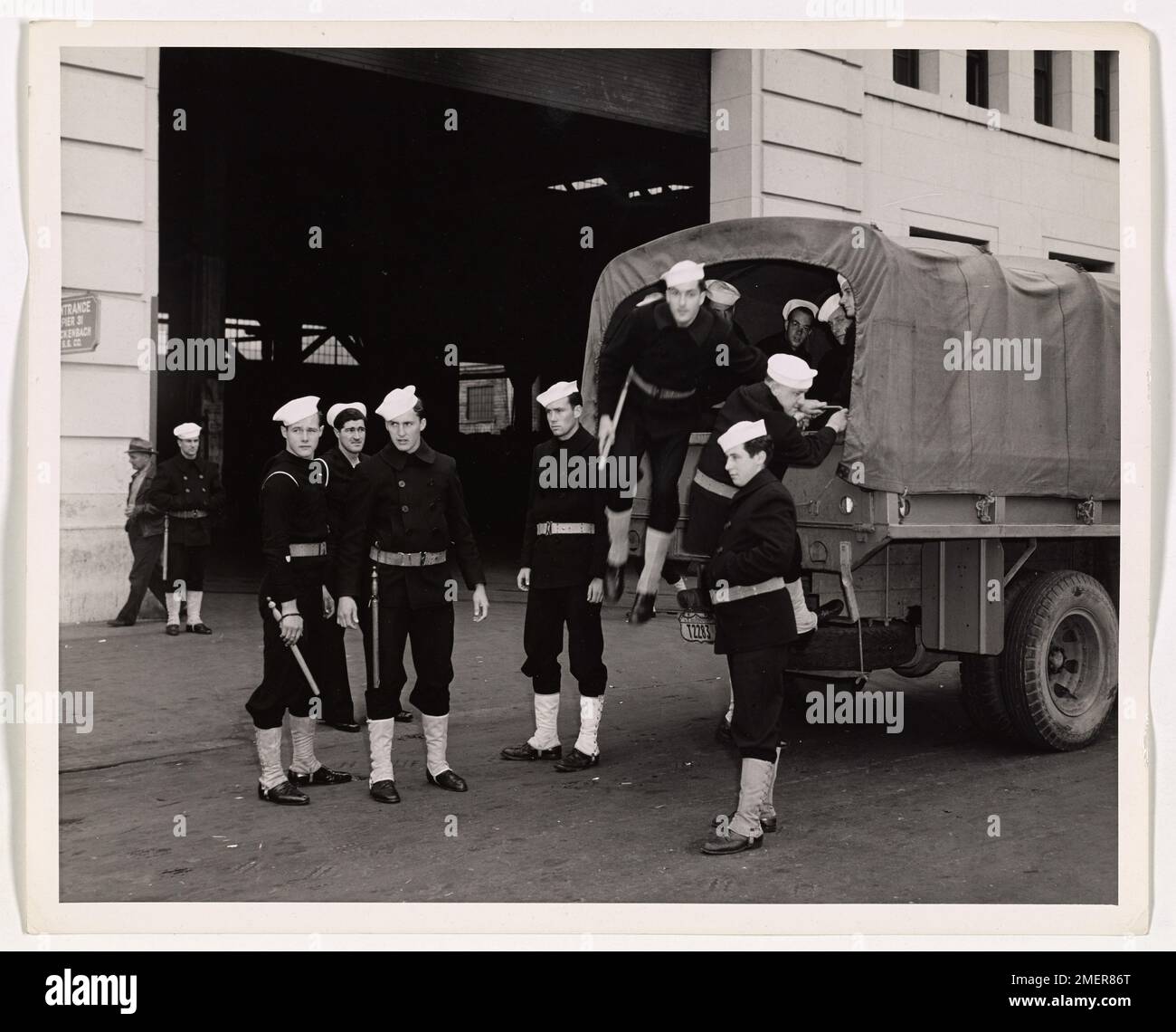 Coast Guardsmen quickly disembark from arriving trucks at the docks ...