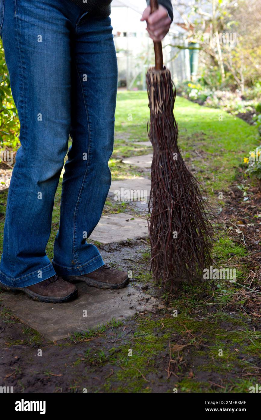 Removing worm casts with besom broom Stock Photo - Alamy