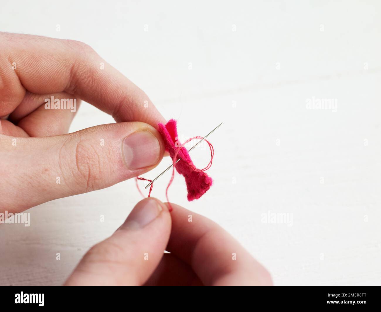 Making felt bow, stitching around the edge using blanket stitch Stock ...