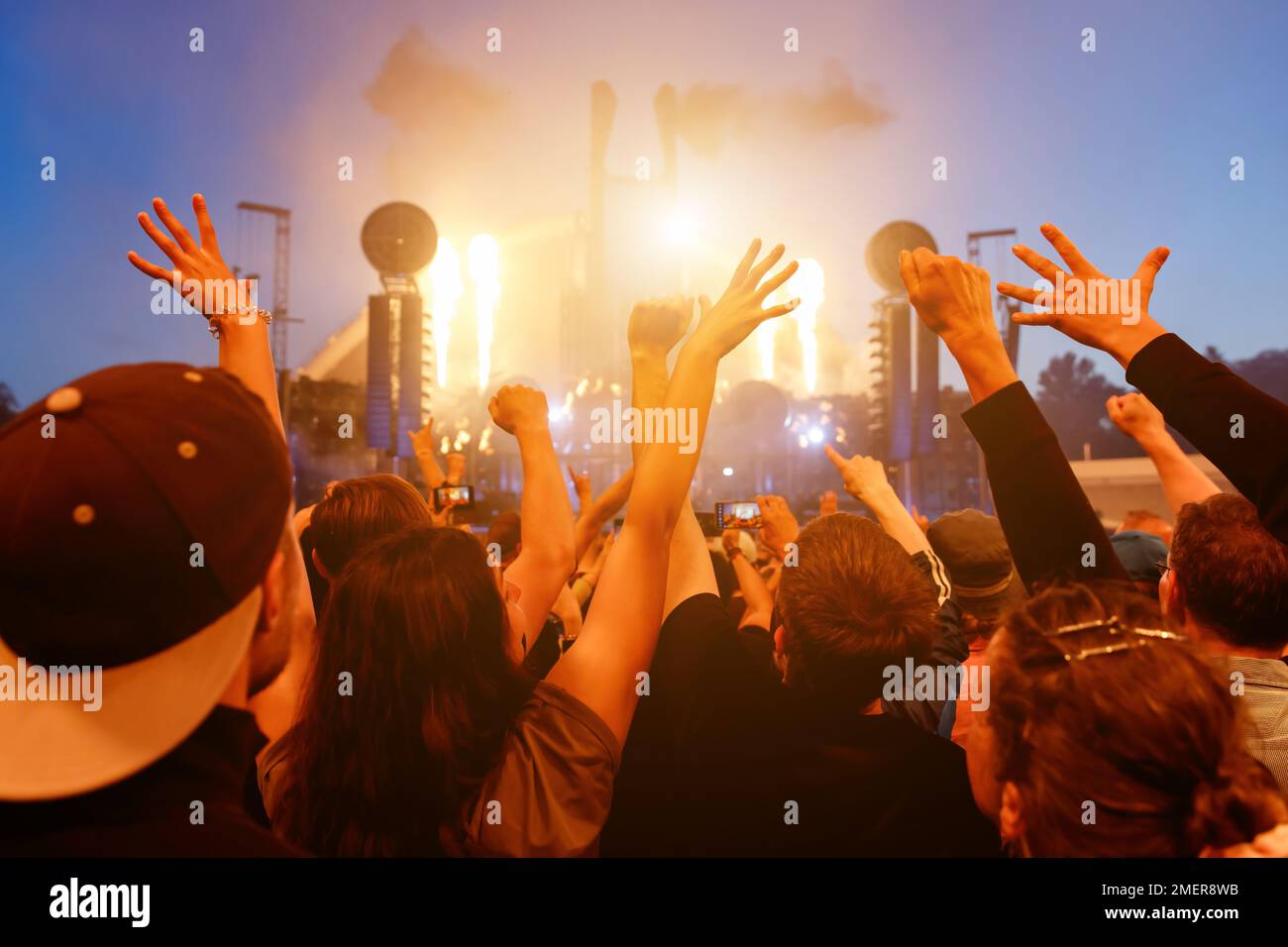A crowd of people with raised arms during a concert Stock Photo - Alamy