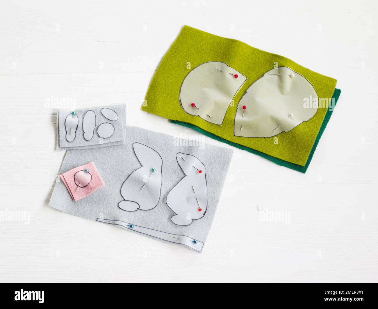 Making felt mouse, placing two pieces of felt together and pinning on ...