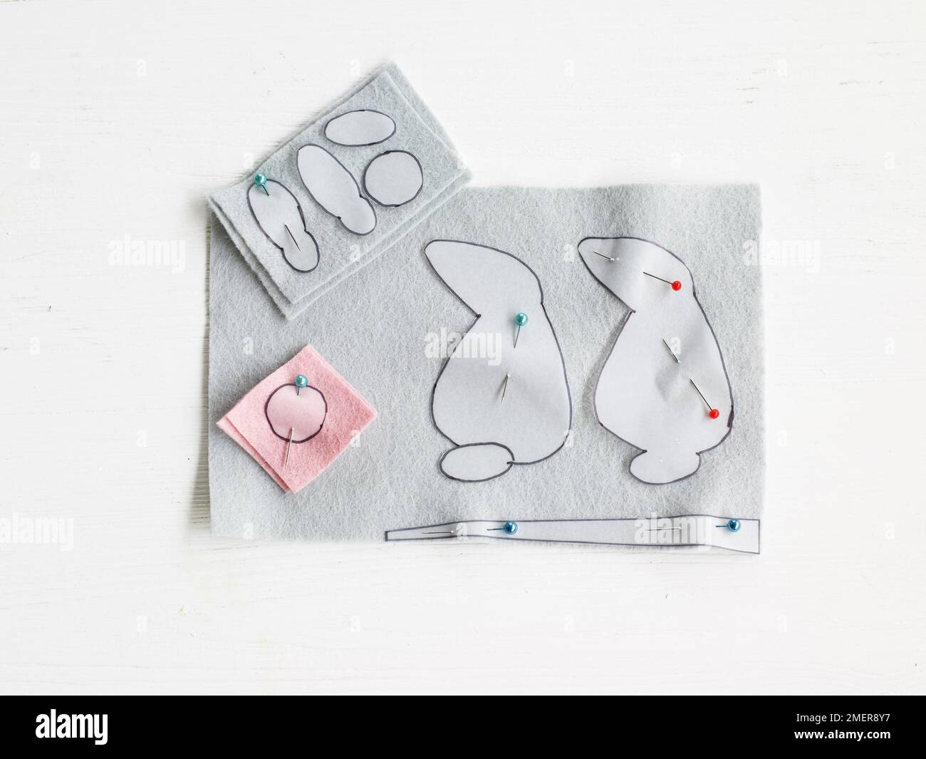 Making felt mouse, placing two pieces of felt together and pinning on ...