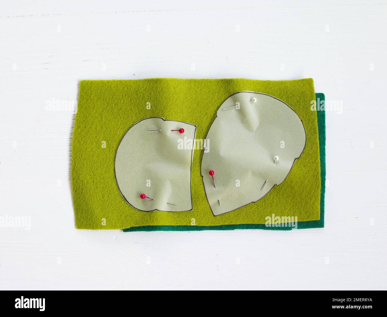 Making felt mouse, placing two pieces of felt together and pinning on ...