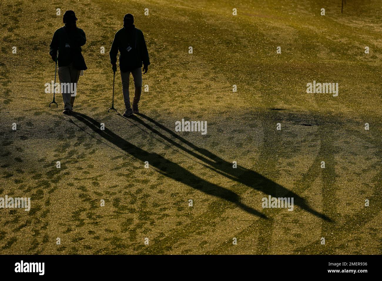 Course workers walk along the first hole during a practice round for ...