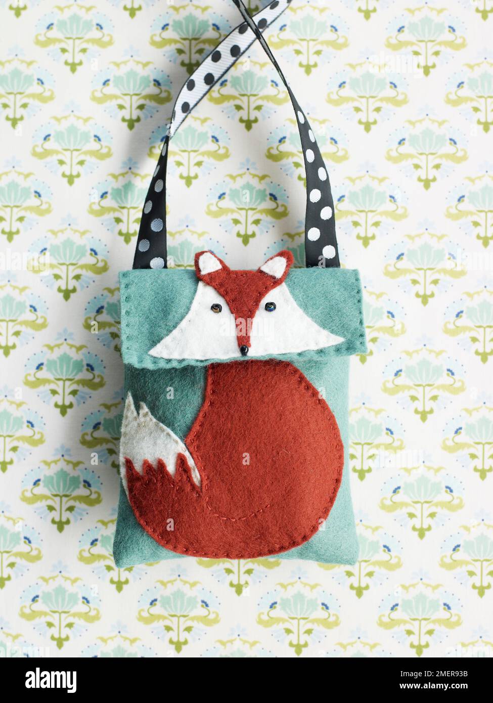 Fox design felt bag hanging from chair Stock Photo - Alamy