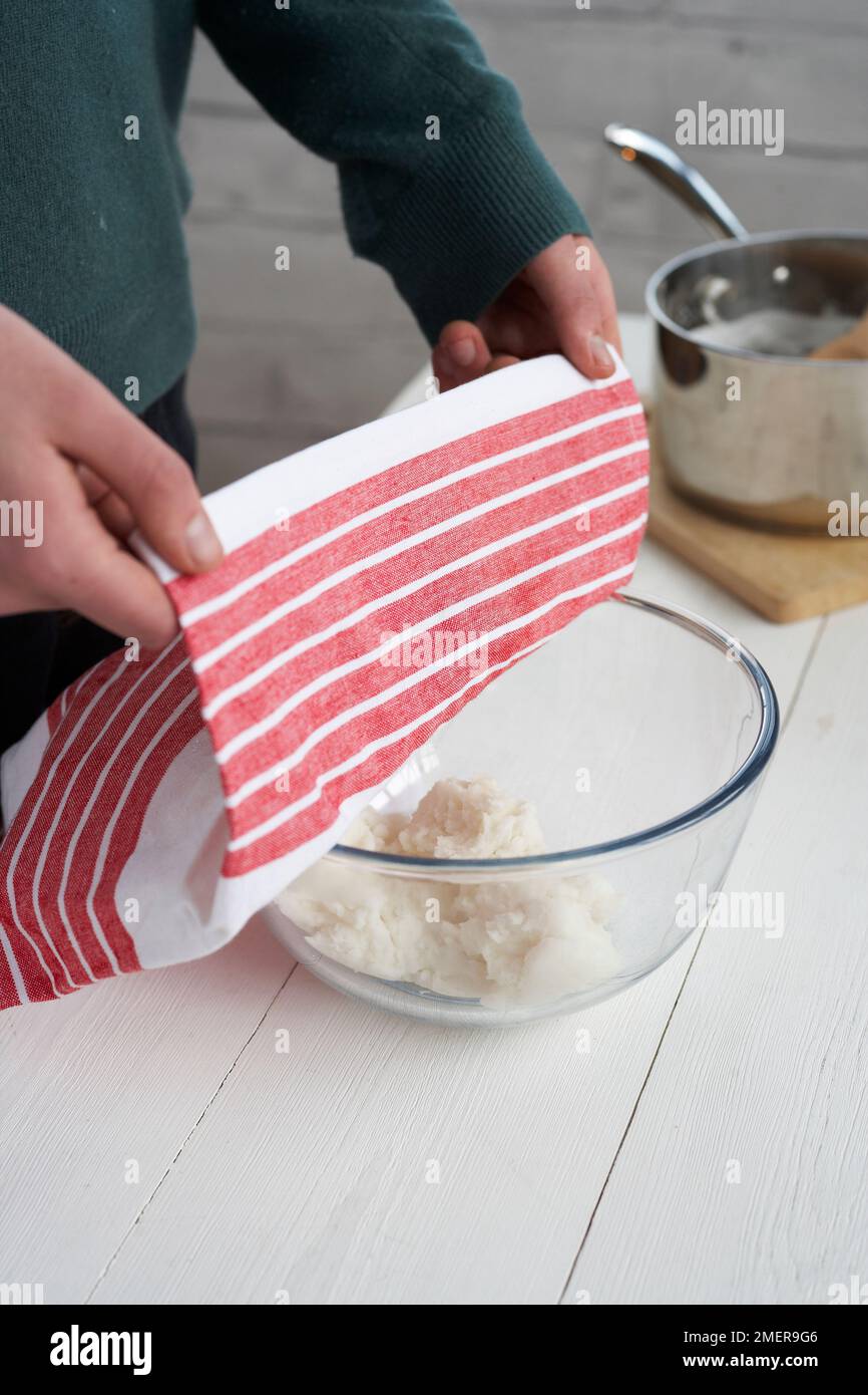 Covering bicarbonate of soda and corn flour mixture with tea towel and ...