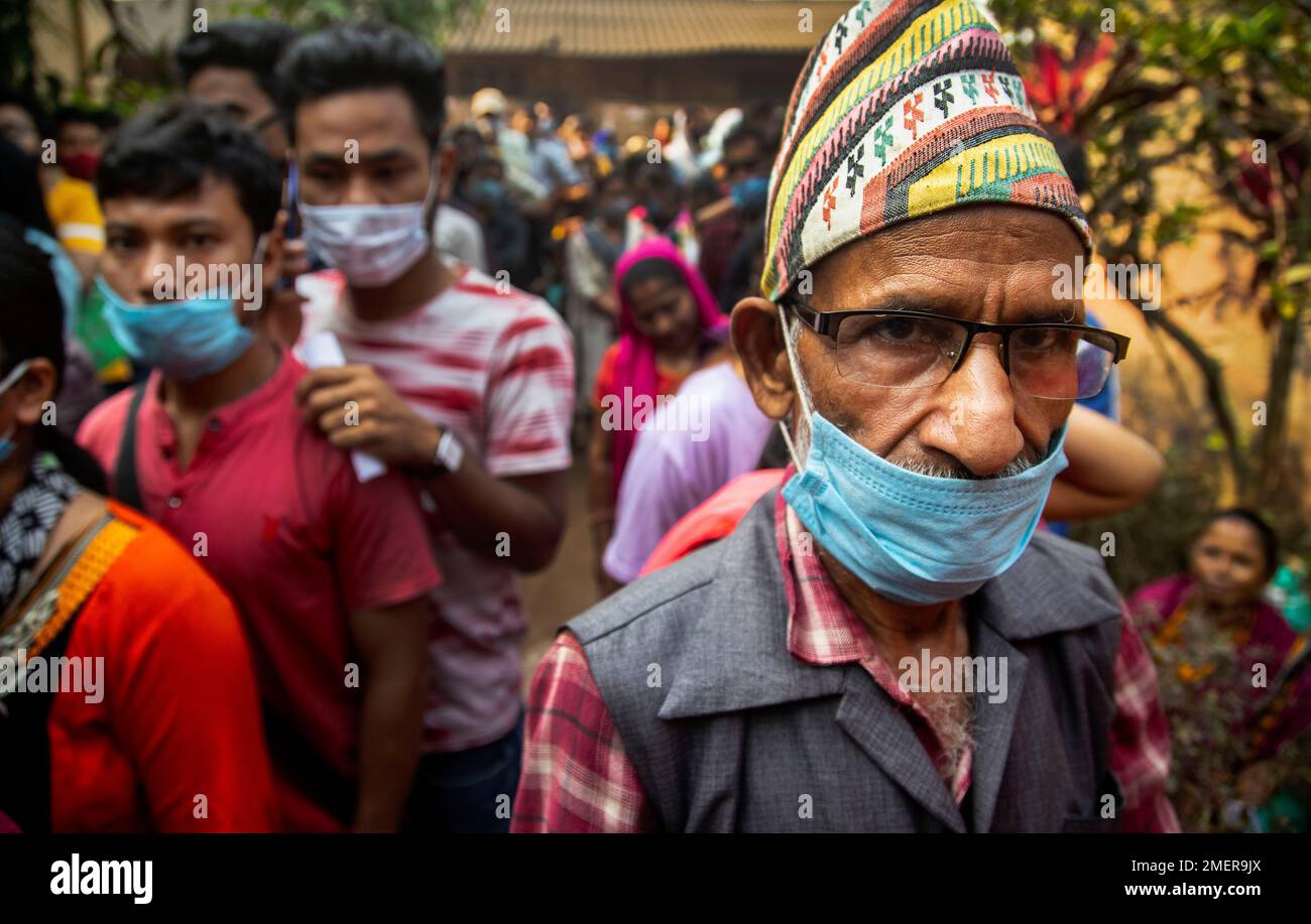 People stand in queue to cast their votes in a polling station during ...