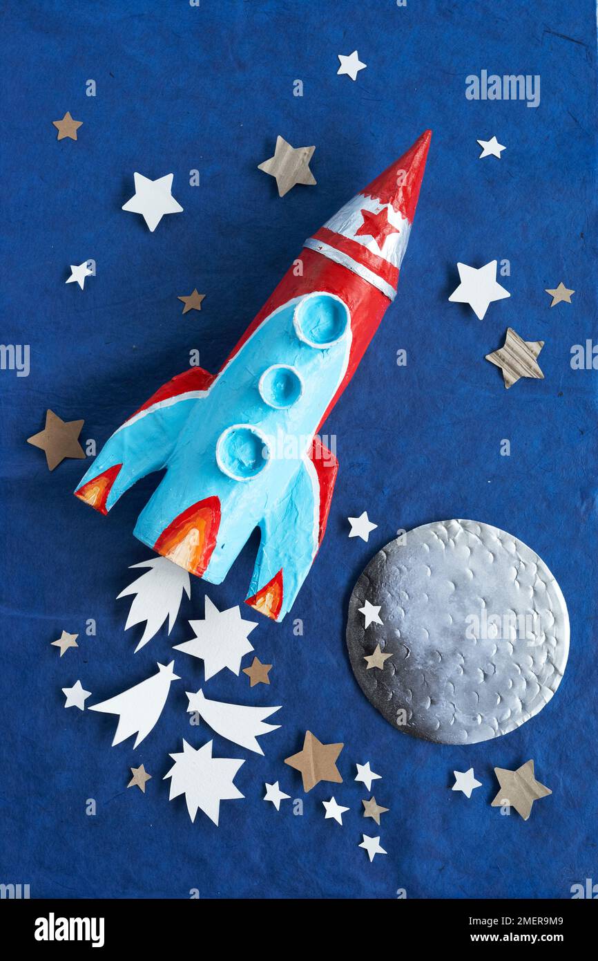Painted papier-mache rocket pen pot Stock Photo - Alamy