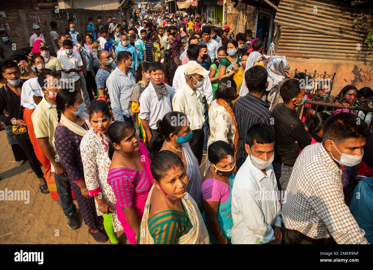 People stand in queue to cast their votes in a polling station during ...