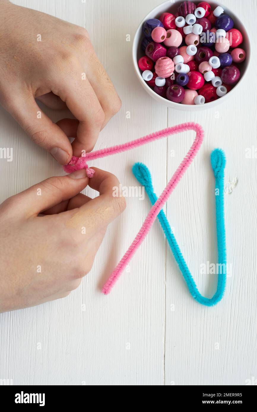 Beads and pipe cleaner Stock Photo - Alamy