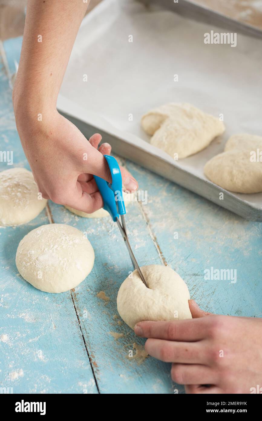 Making heart shaped bread rolls, cutting into dough ball Stock Photo ...