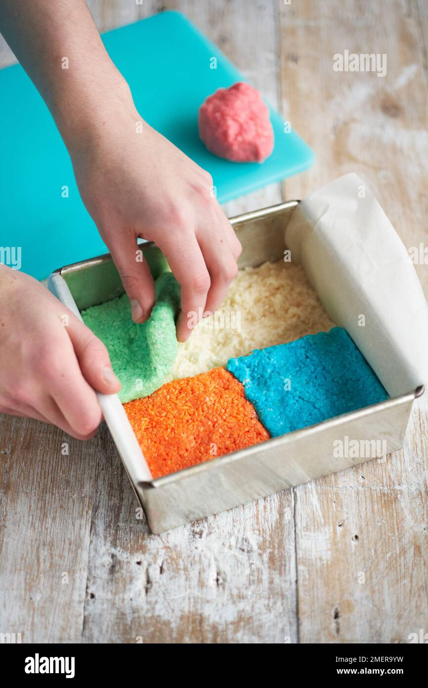 Making coconut bites, creating coloured layers Stock Photo - Alamy