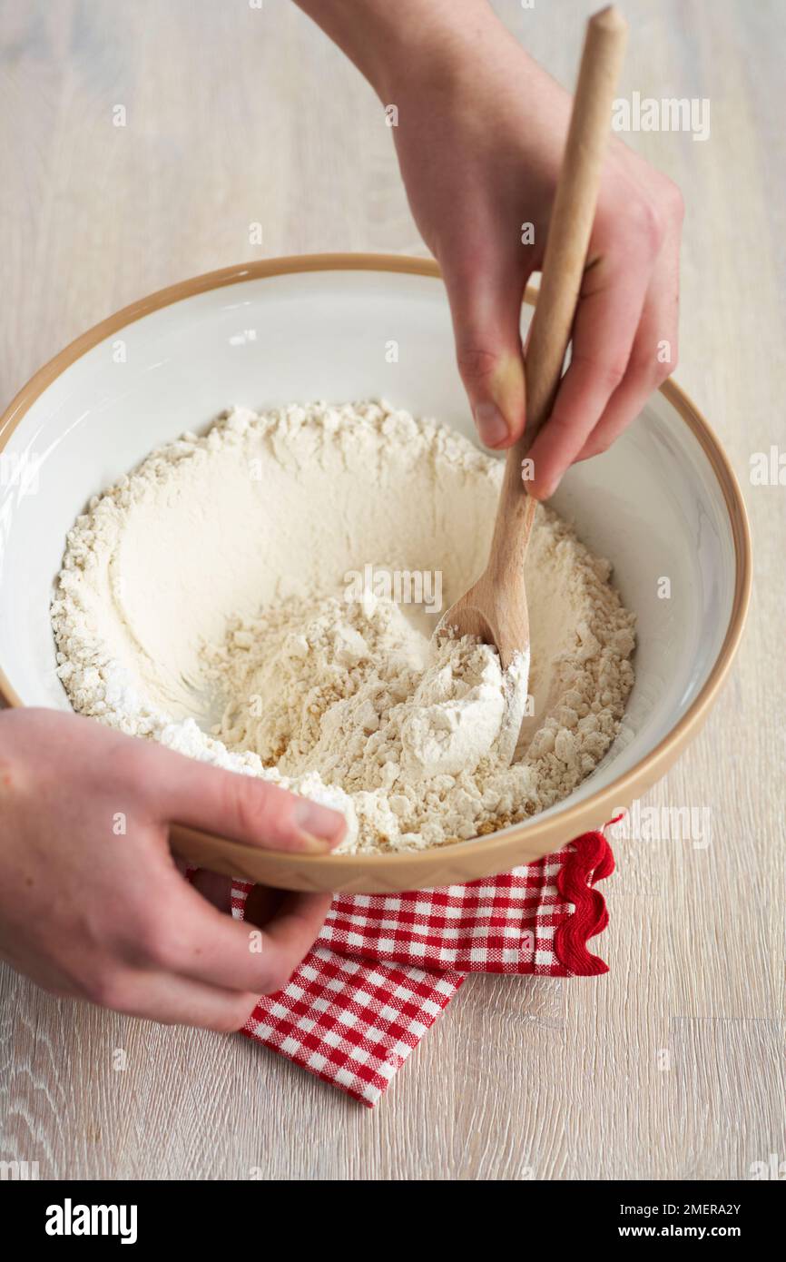 Mixing flour, bicarbonate of soda and ginger, making gingerbread biscuits Stock Photo - Alamy