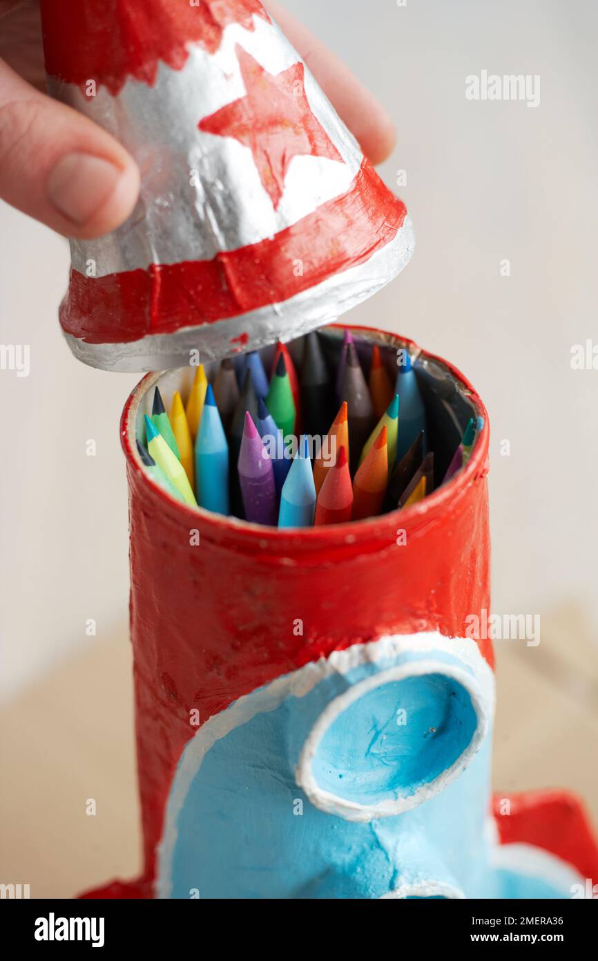 Pen holder in shape of rocket Stock Photo - Alamy