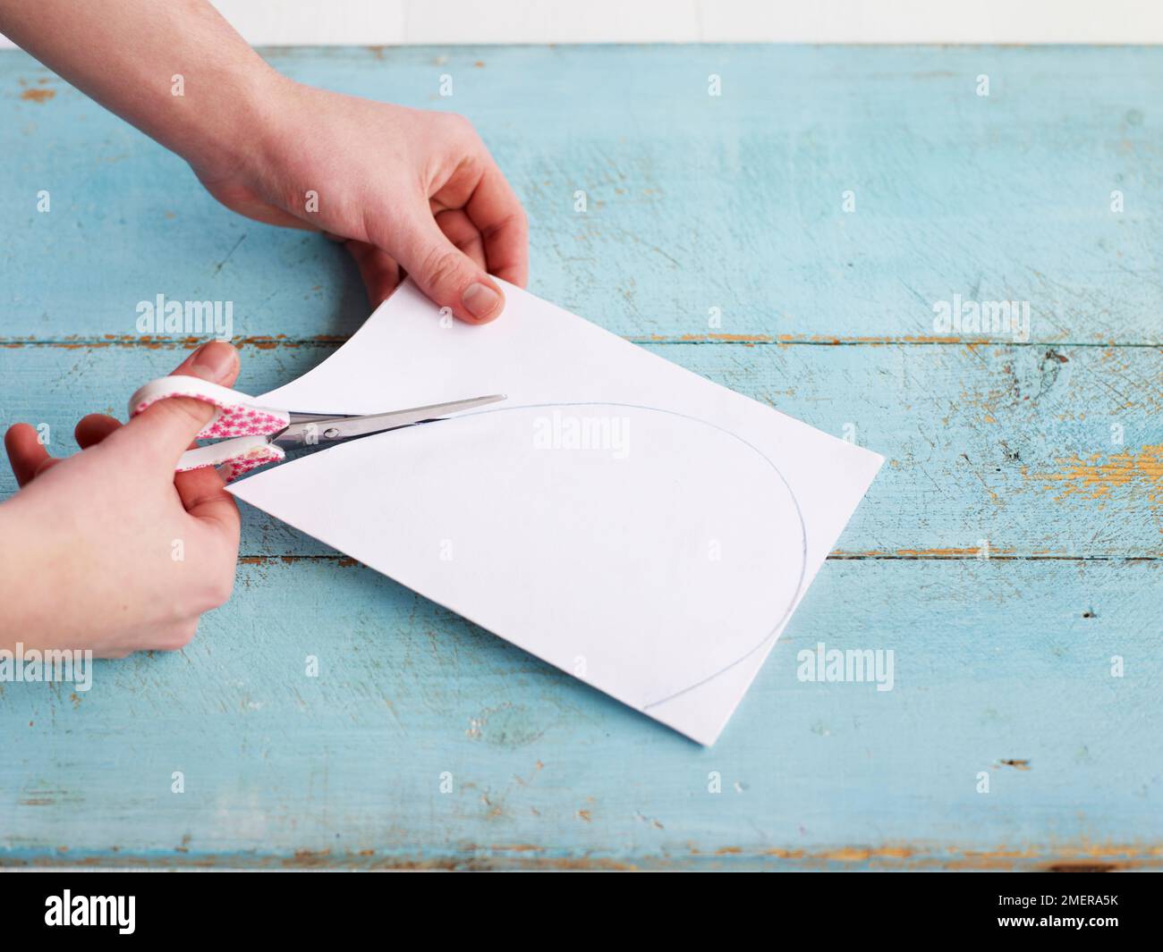 Making envelope, cutting along outline of heart shape Stock Photo - Alamy