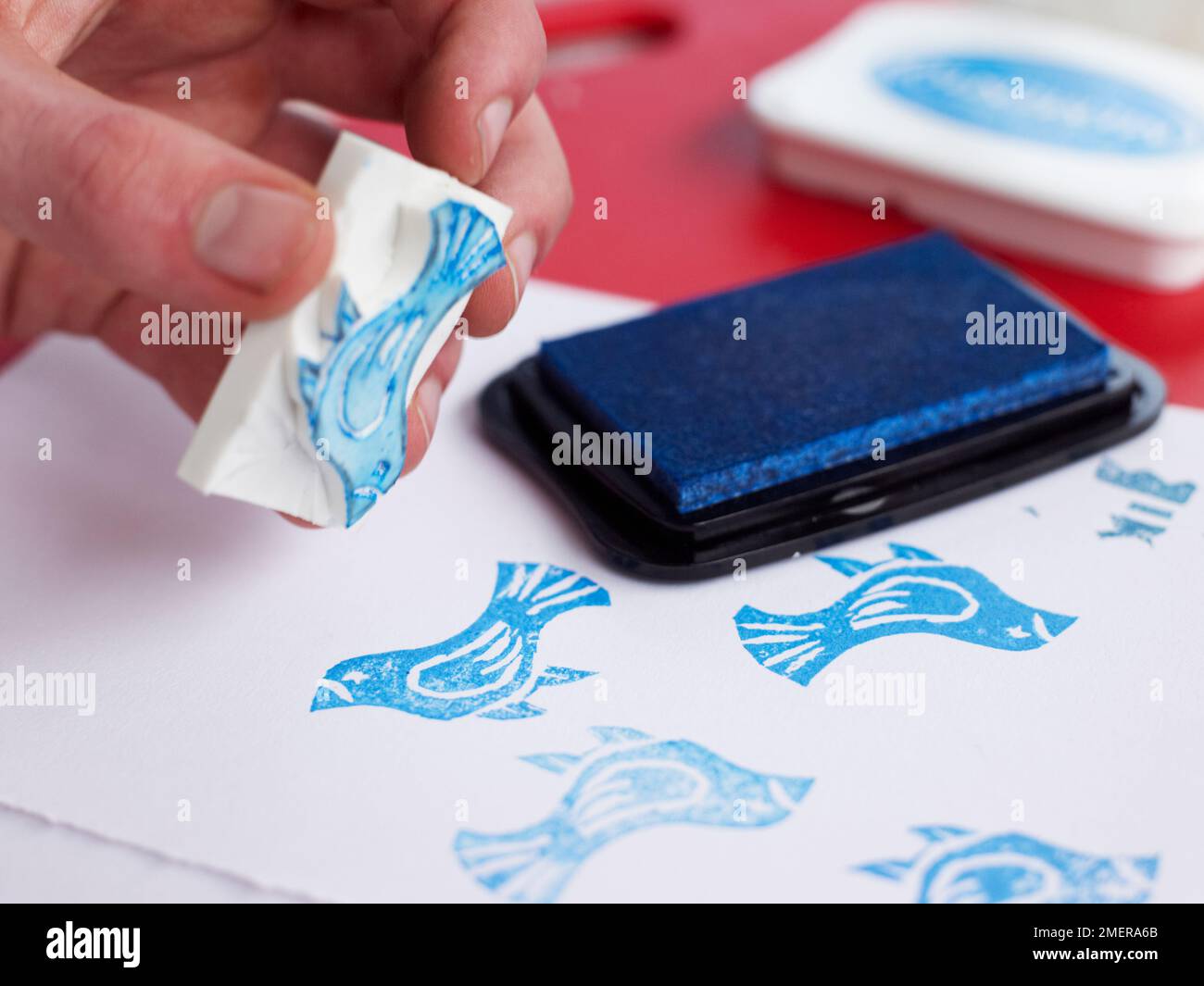 Stamping bird pattern on paper, making wrapping paper Stock Photo - Alamy