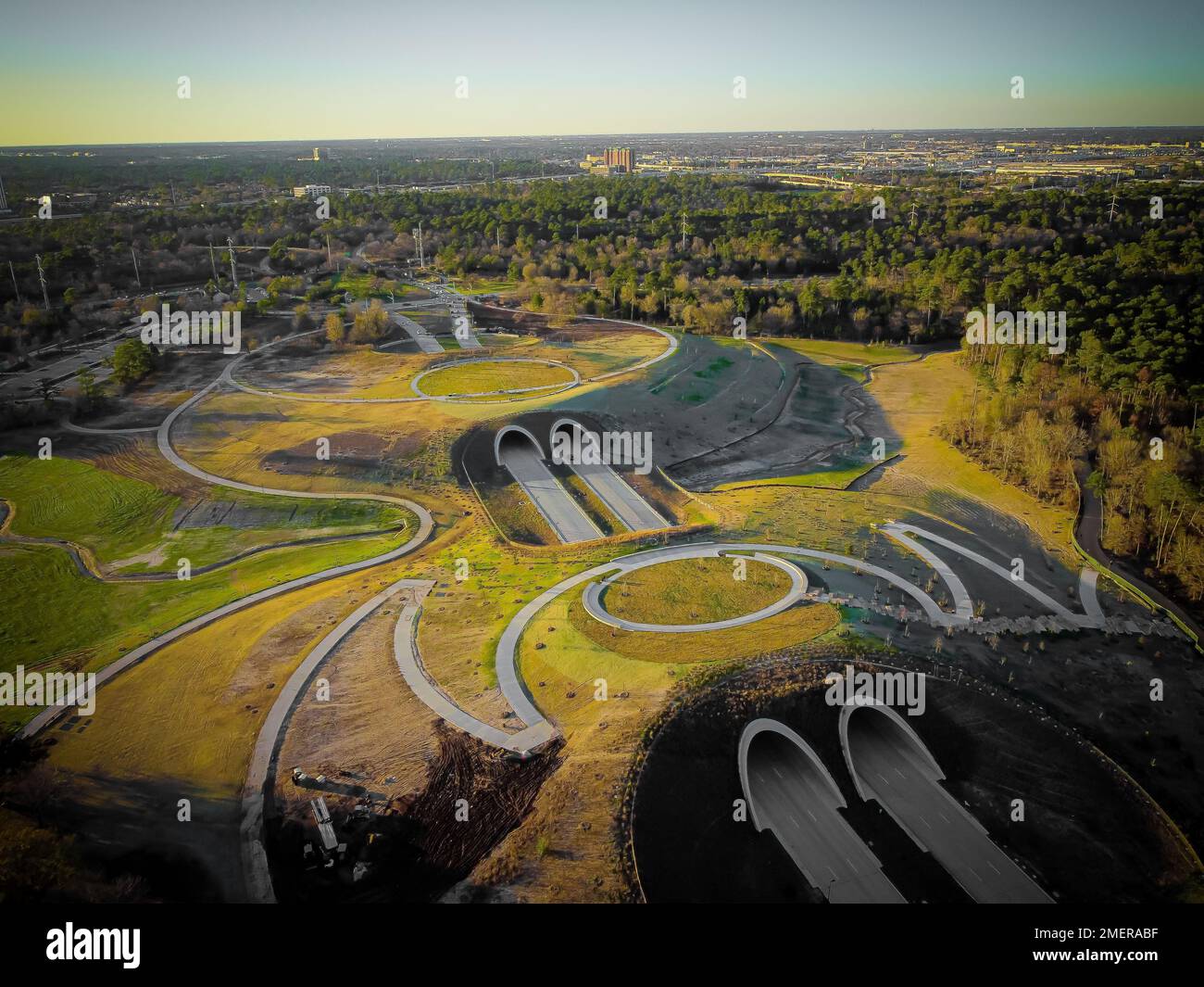 An aerial view of a green landscape with long asphalt roads in a rural ...