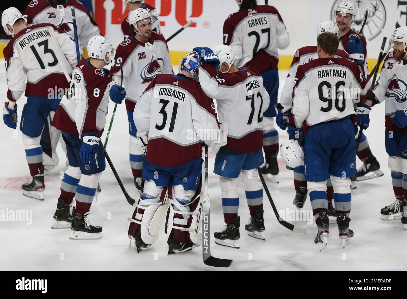 Colorado Avalanche's Joonas Donskoi (72) pats goalie Philipp Grubauer ...
