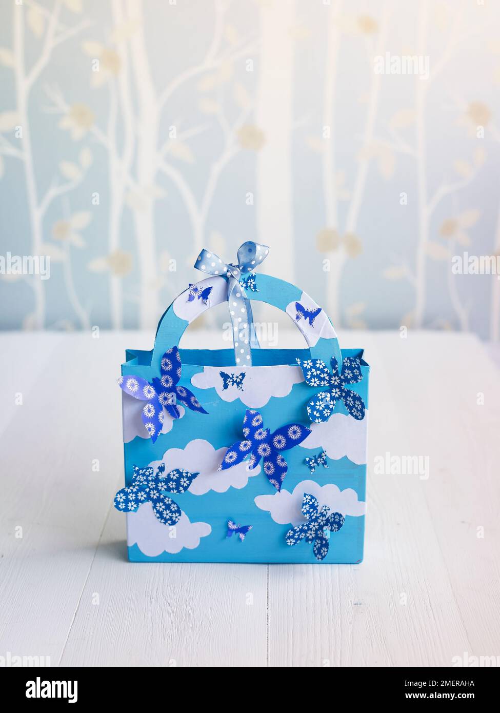 Blue present bag with paper butterfly decorations Stock Photo - Alamy