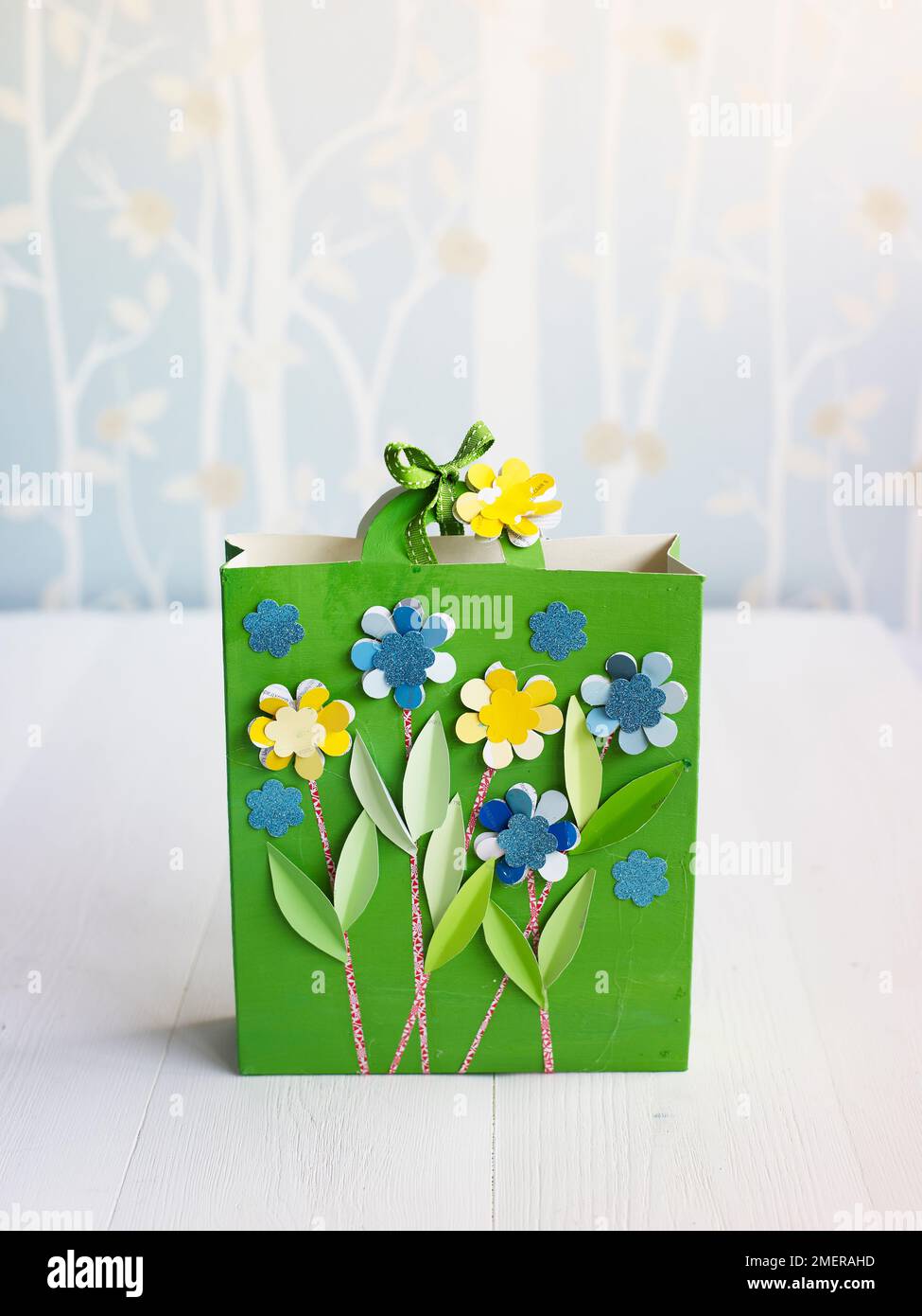 Present bag with paper flower decorations Stock Photo - Alamy