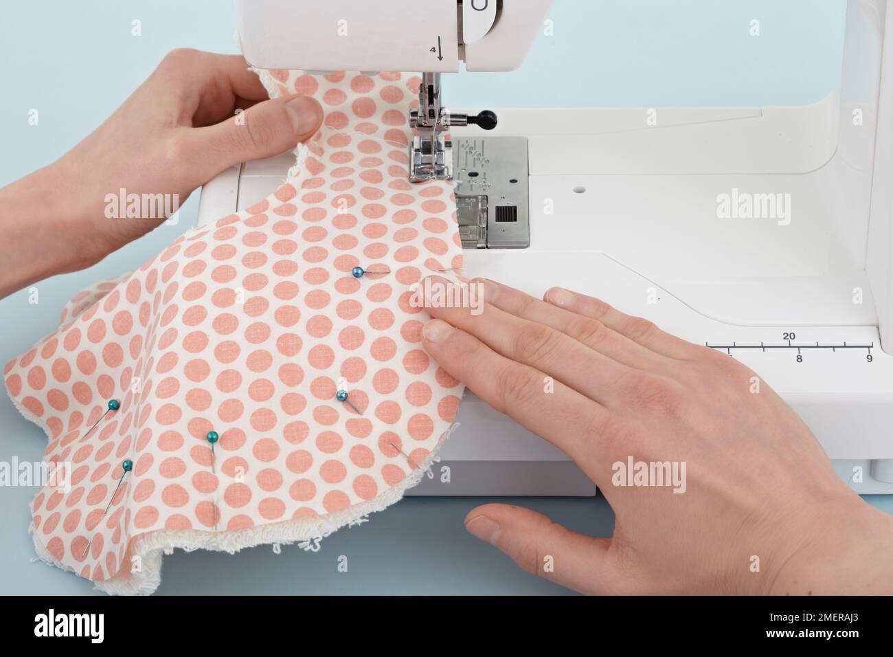Making a bib, pin and sew fabric and toweling together Stock Photo - Alamy