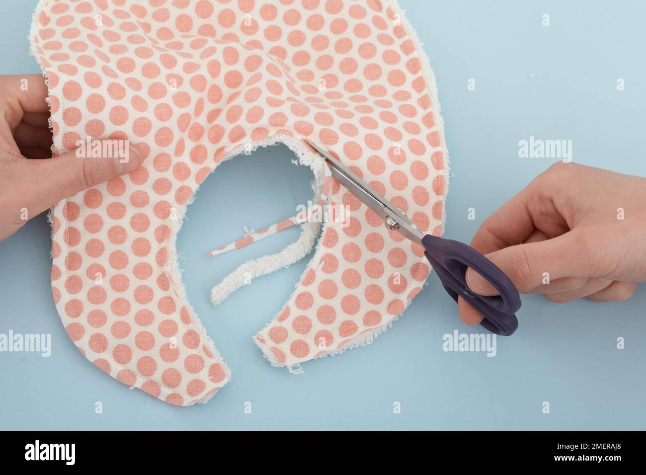 Making a bib, trim the seam allowance Stock Photo - Alamy