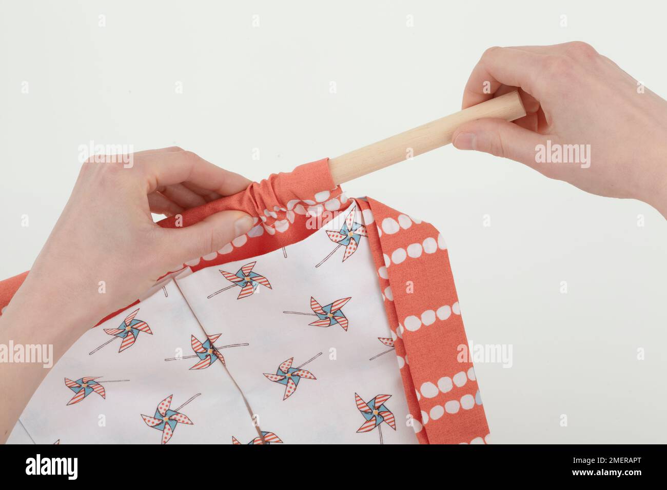 Insert dowel rod into channel in fabric, making cot hanger or cot ...