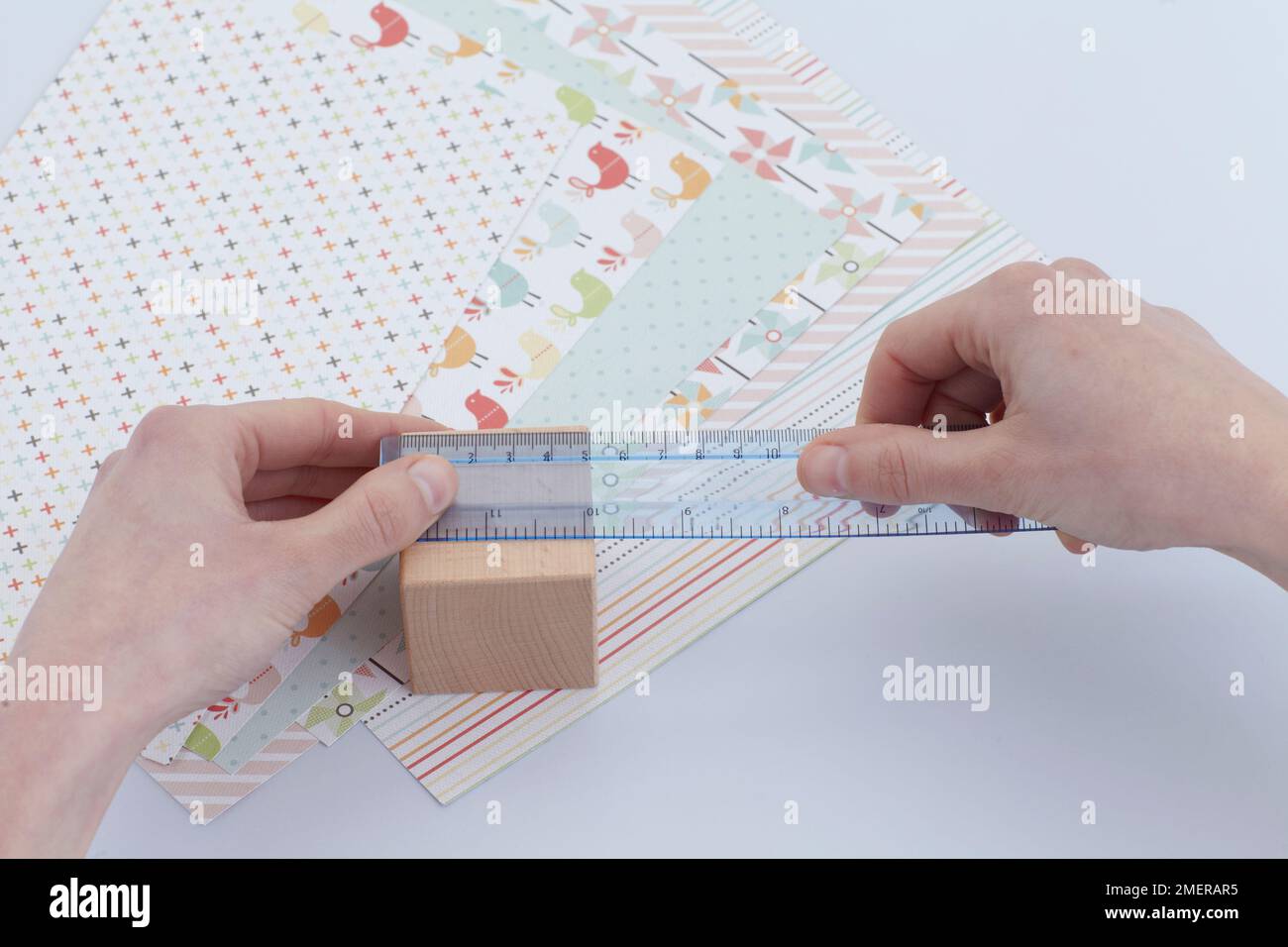 Measuring side of block with ruler, decoupage block Stock Photo - Alamy