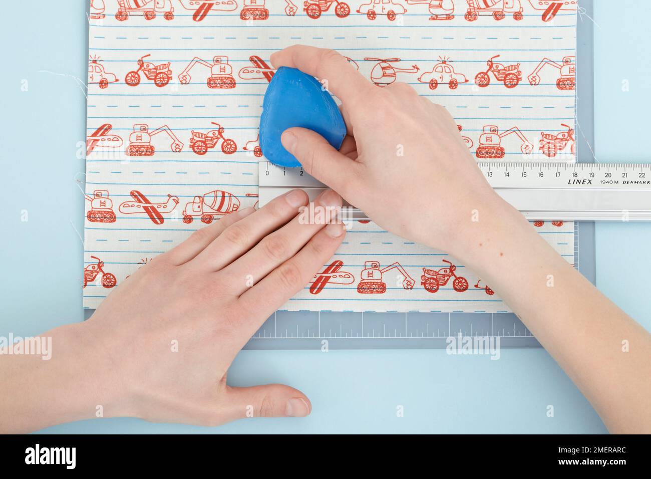 Measure and mark fabric with ruler and tailor's chalk Stock Photo - Alamy